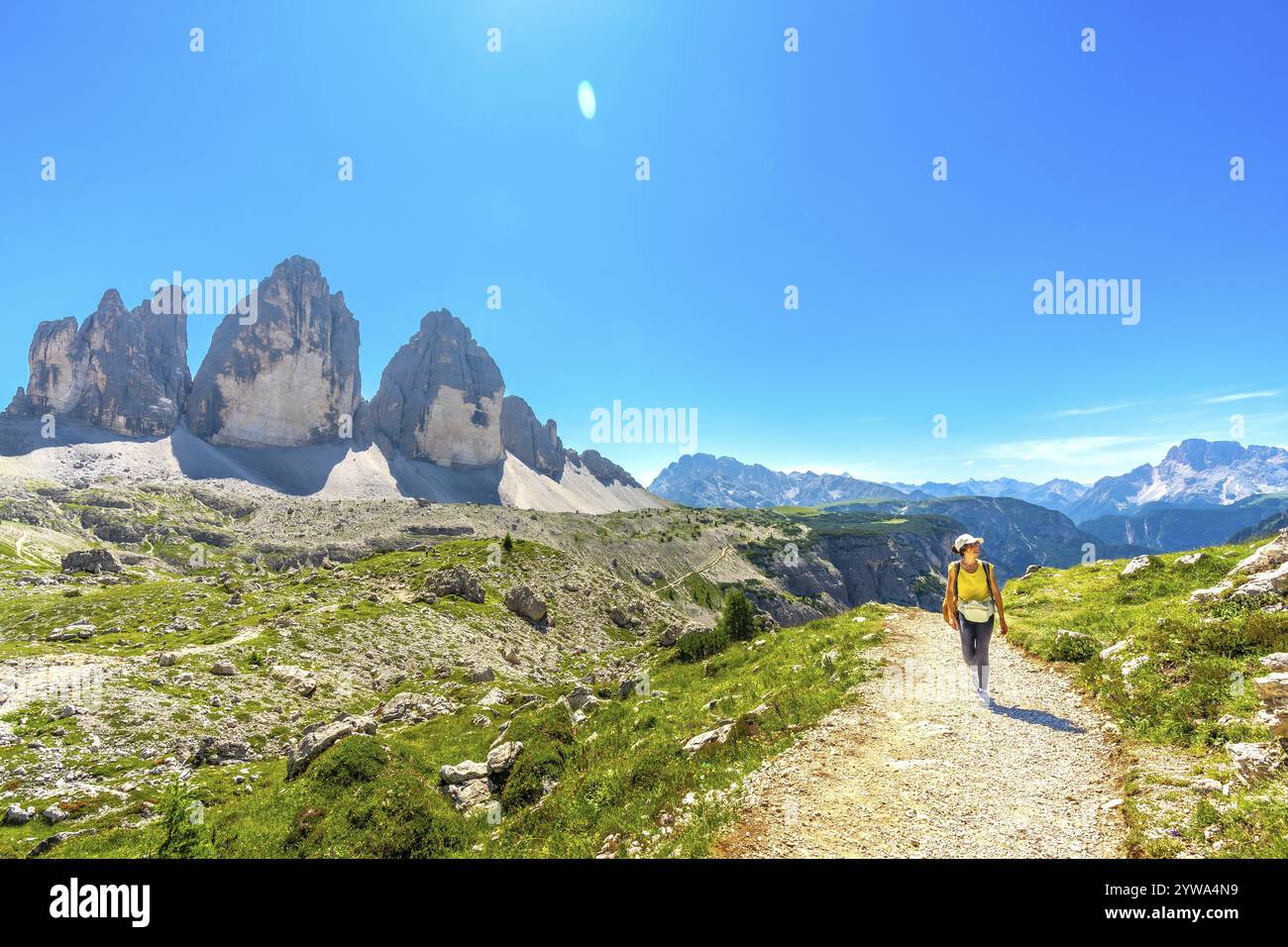 Tourist walking on a mountain path near tre cime di lavaredo, a symbol ...