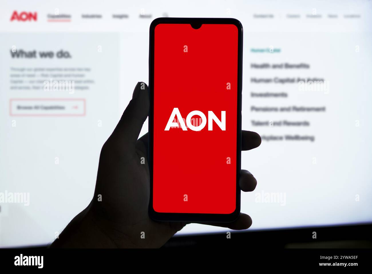 Smartphone displaying logo of Aon PLC, a British multinational professional services firm that ...
