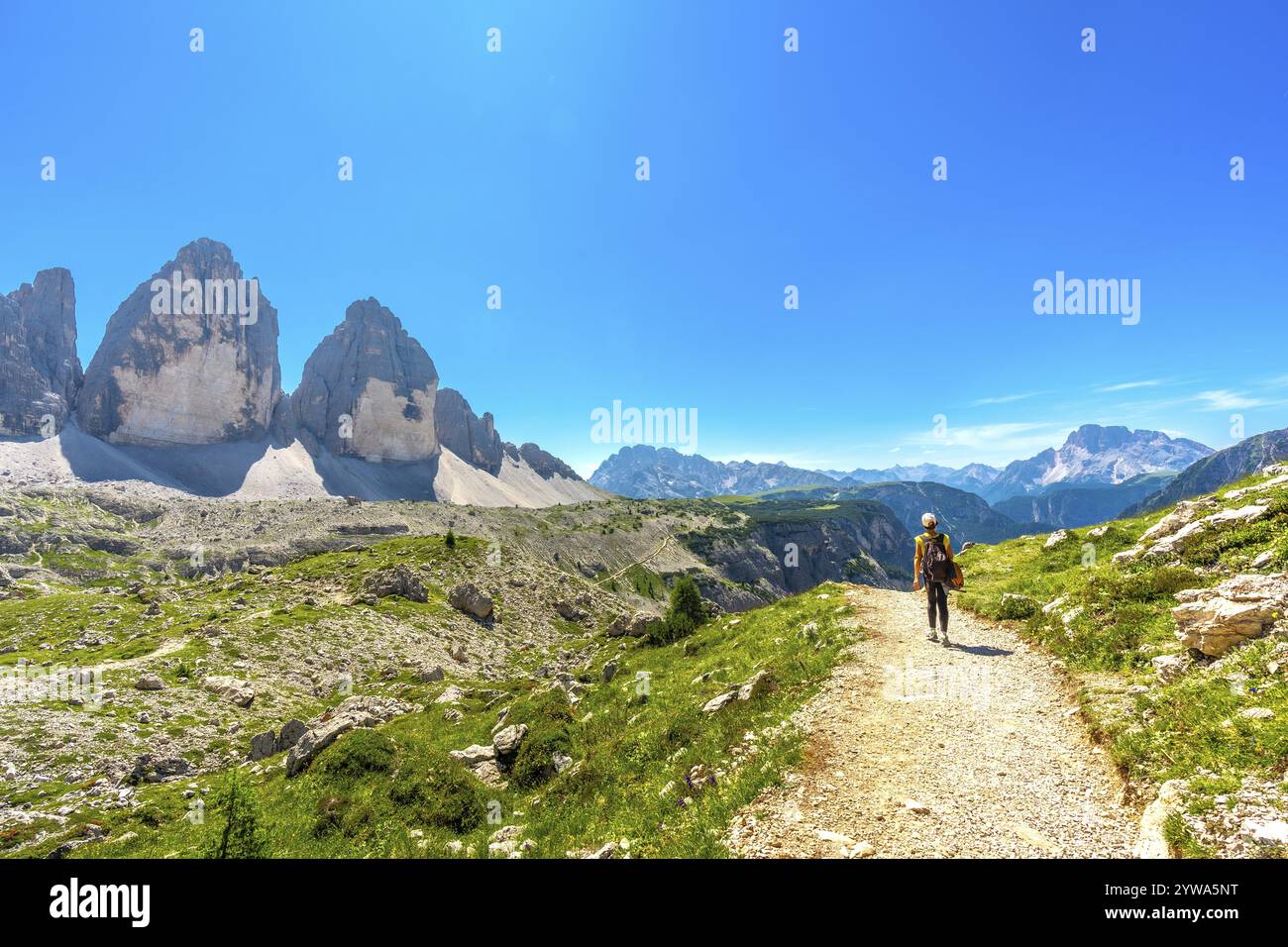 Tourist walking on a mountain path near tre cime di lavaredo in the ...