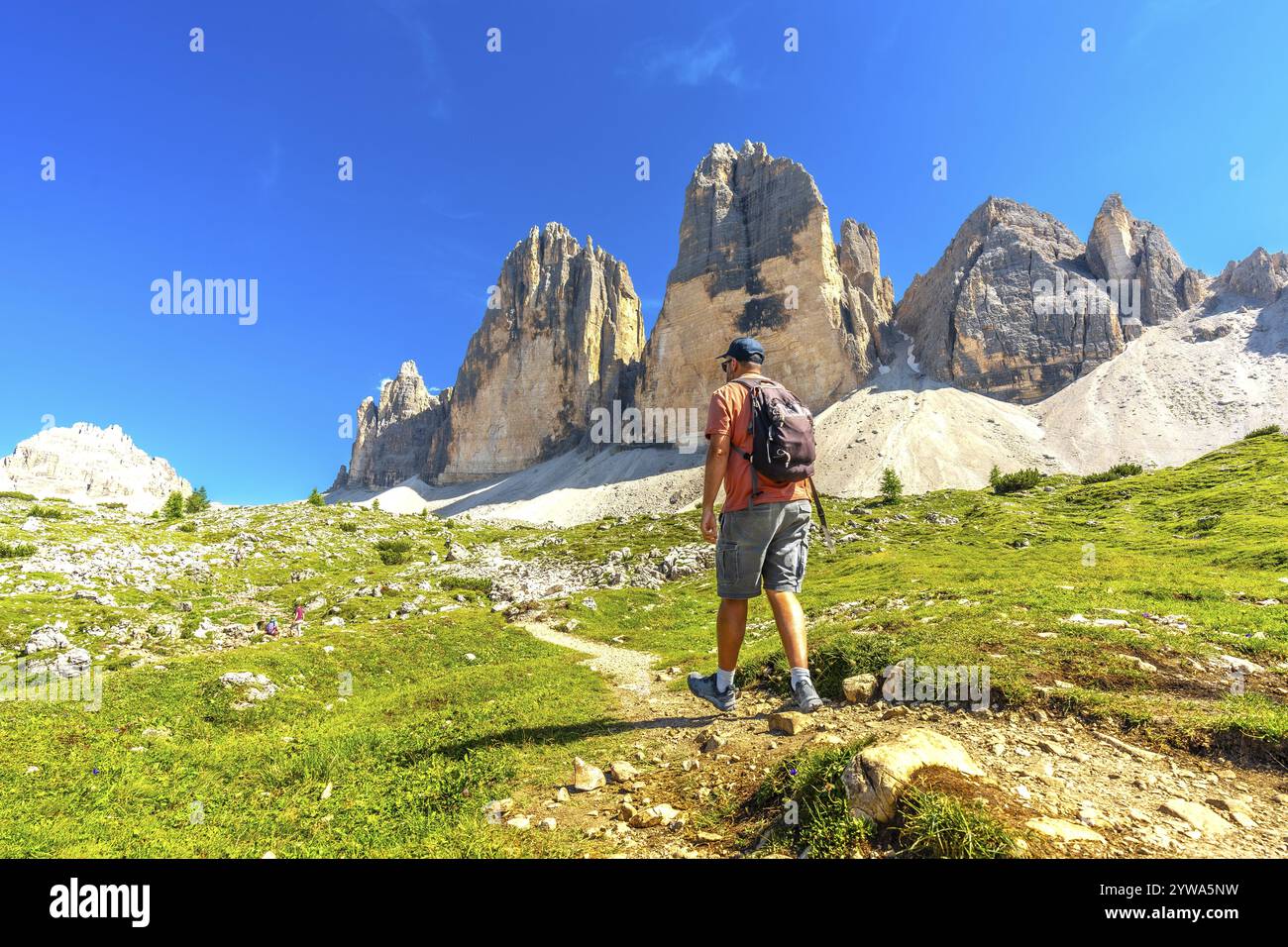 Tourist enjoying a scenic hike on the tre cime di lavaredo trail amidst ...
