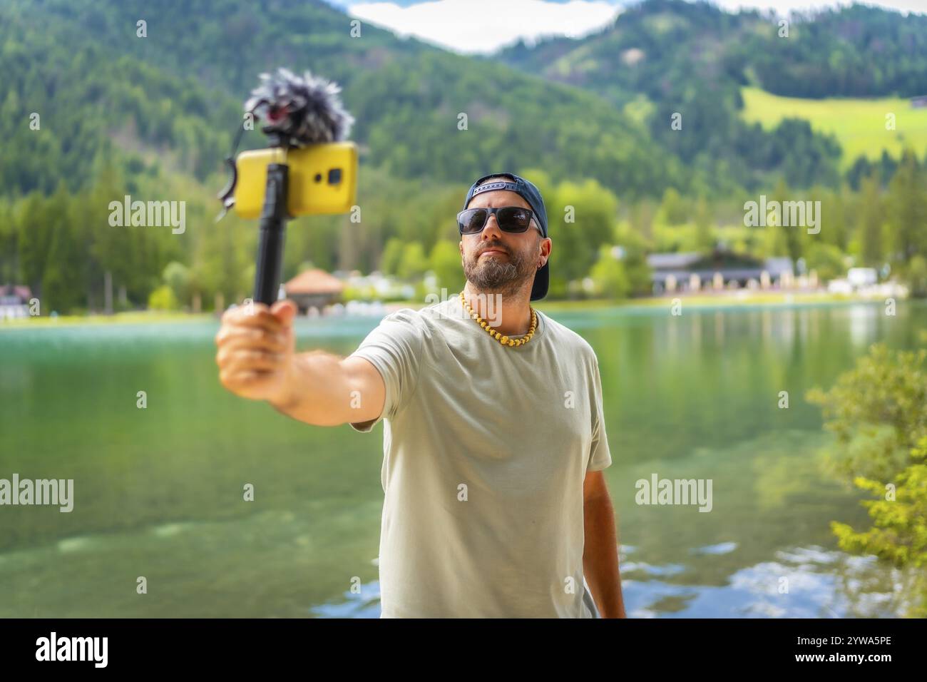 Content creator filming a video with a smartphone and external ...