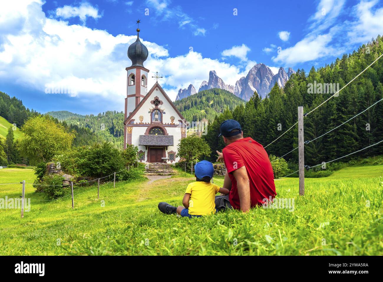 Father and son admiring the stunning view of the idyllic st. Magdalena ...