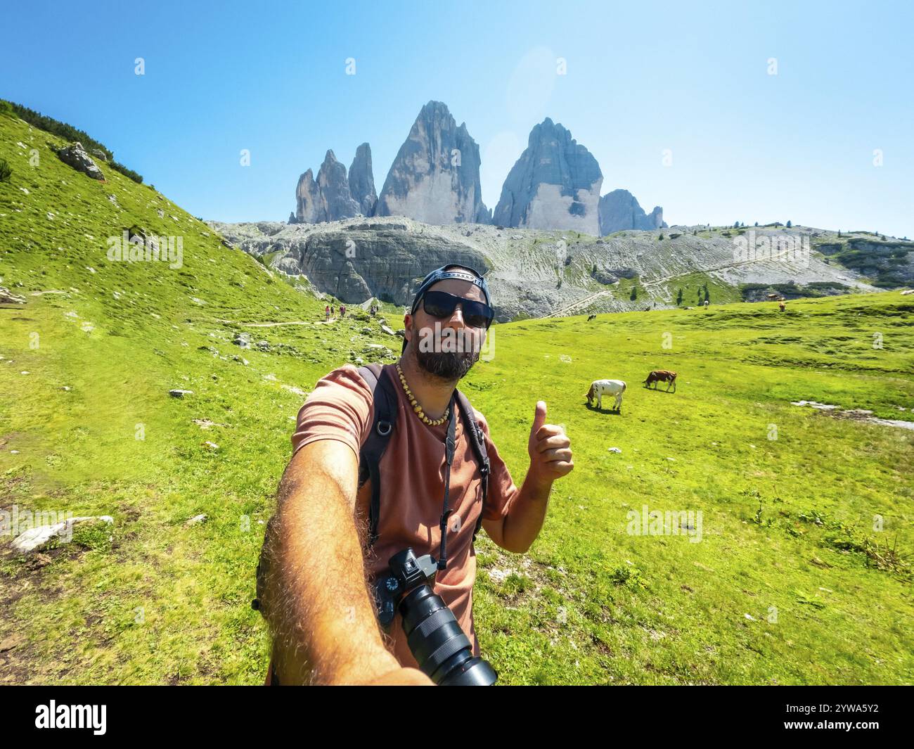 Photographer taking a selfie with thumbs up sign while hiking on a ...