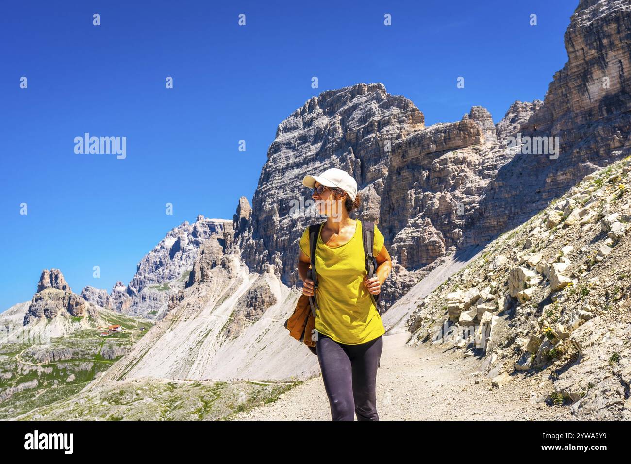 Female hiker walking on a sunny summer day on the scenic tre cime di ...