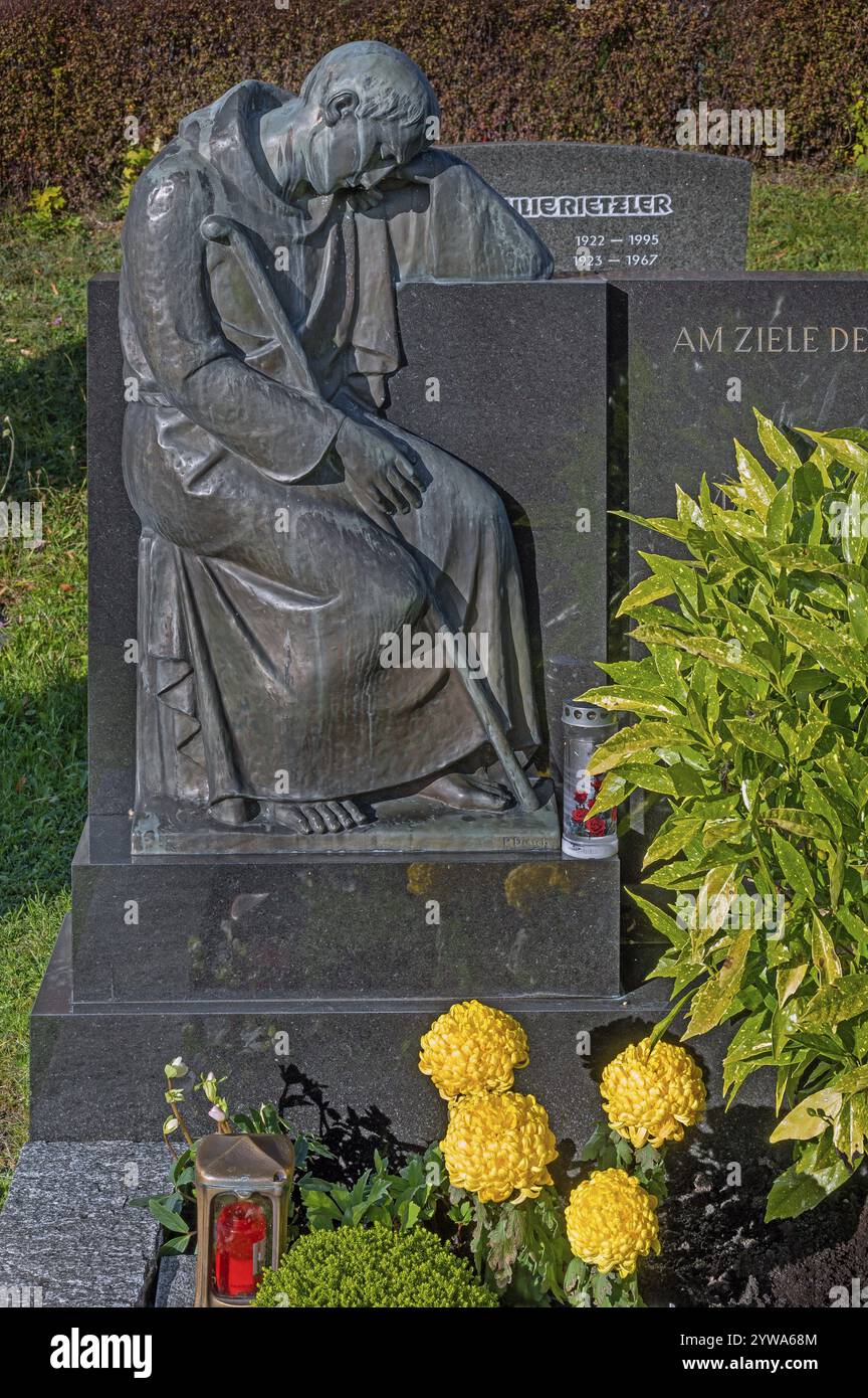 Gravestone with mourning male figure and floral decoration at the ...