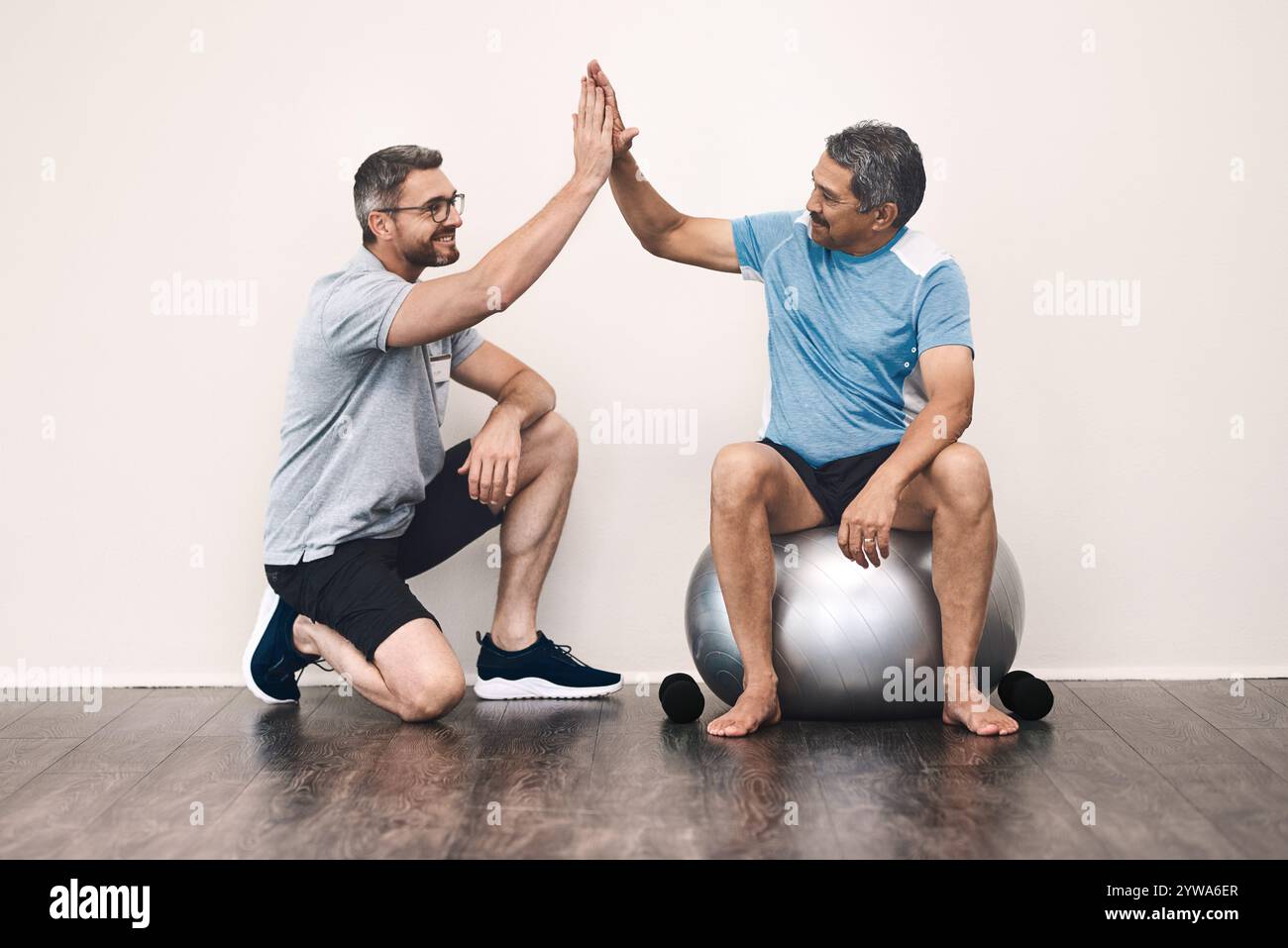 Physical therapy, people and high five for recovery at clinic, joint ...