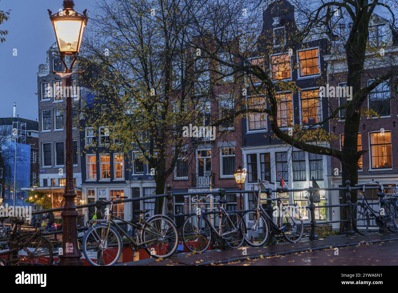 Evening atmosphere in a Dutch city with bicycles and illuminated ...
