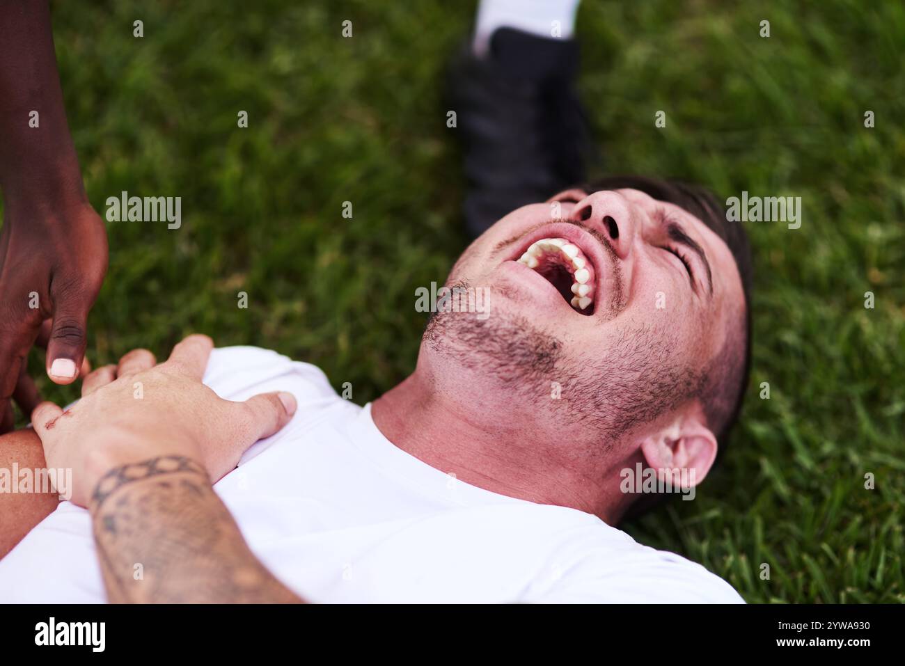 Man, screaming and shoulder pain with sports injury on grass field for ...