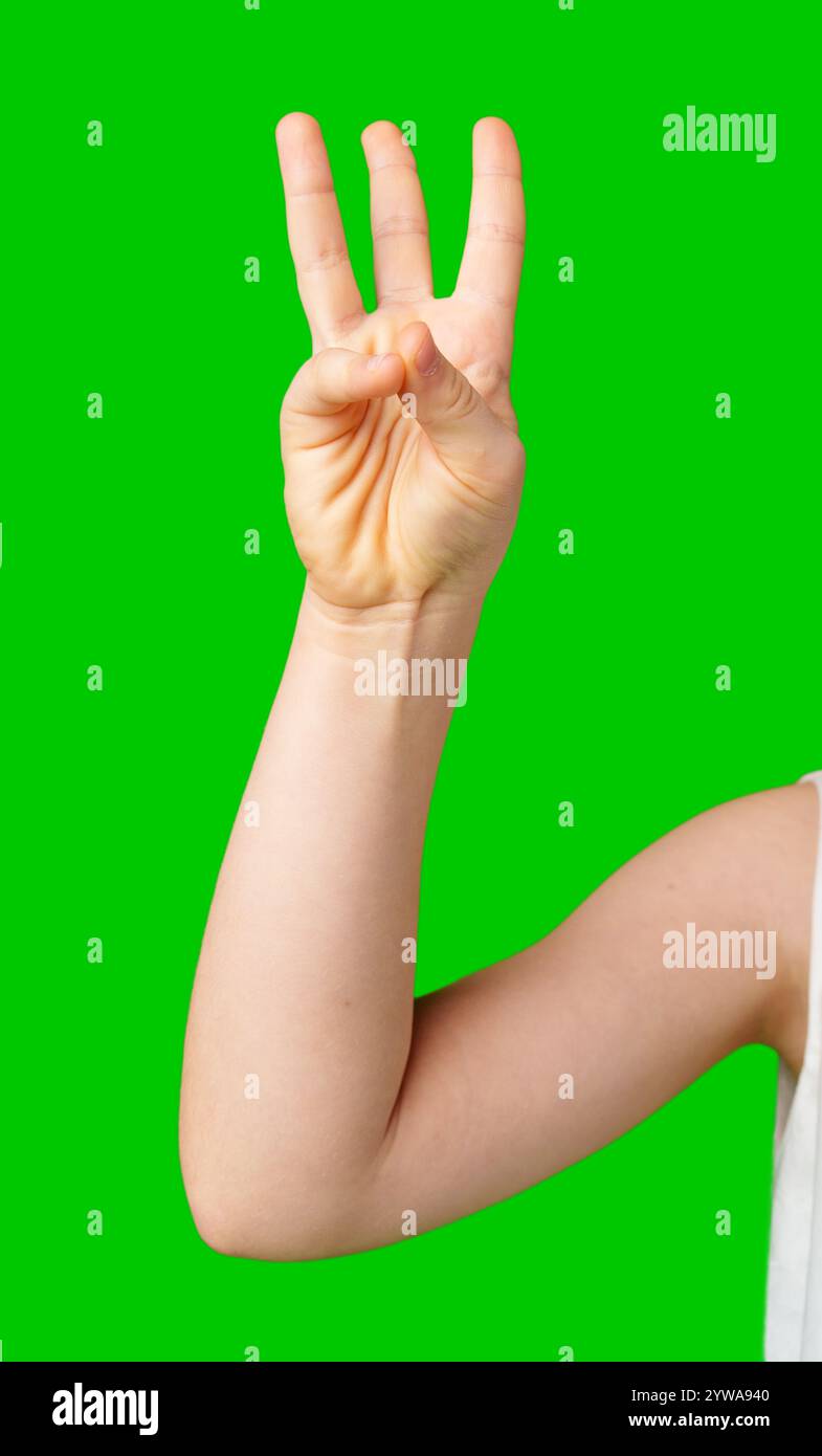 A hand showing the number three against a bright green background Stock ...