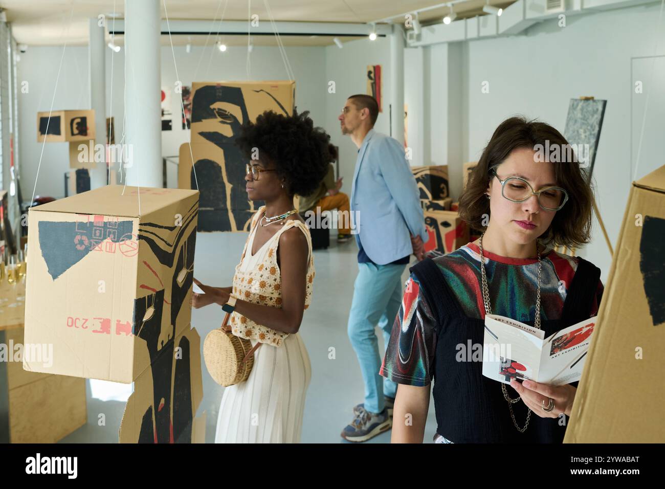 Group of young intercultural visitors of modern art gallery attending ...