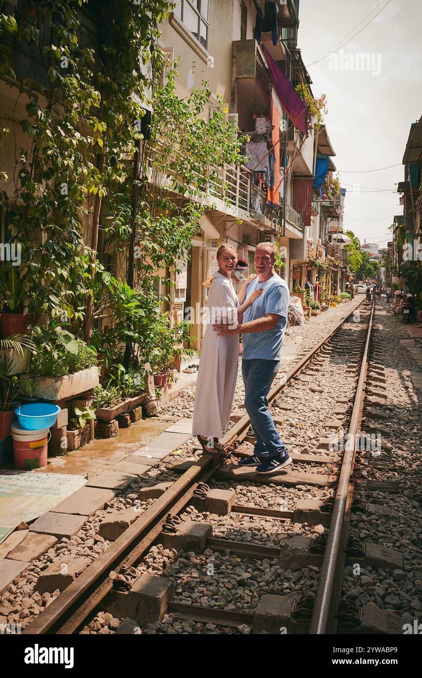 Travel, couple and happy in portrait on train track for holiday ...