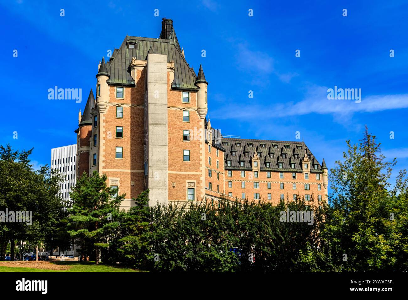 A large brick building with a steeple and a clock tower. The building ...