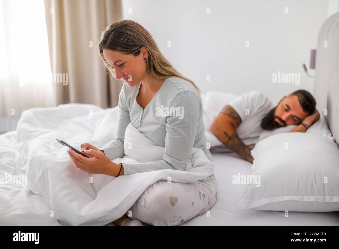 Wife is cheating on her husband. She is messaging on smartphone Stock ...