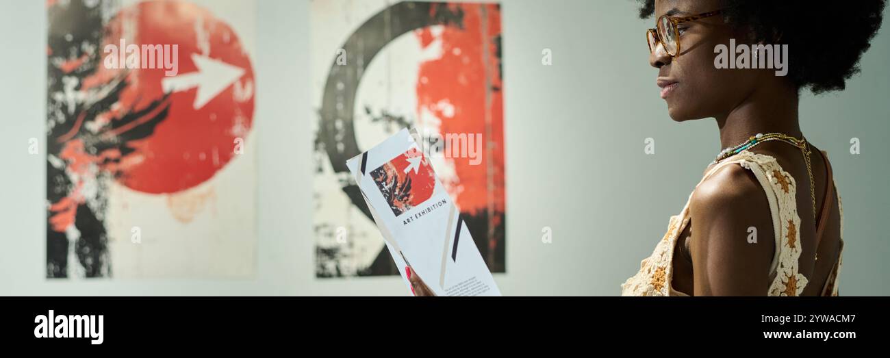 Header of young serious African American female visitor of modern art ...