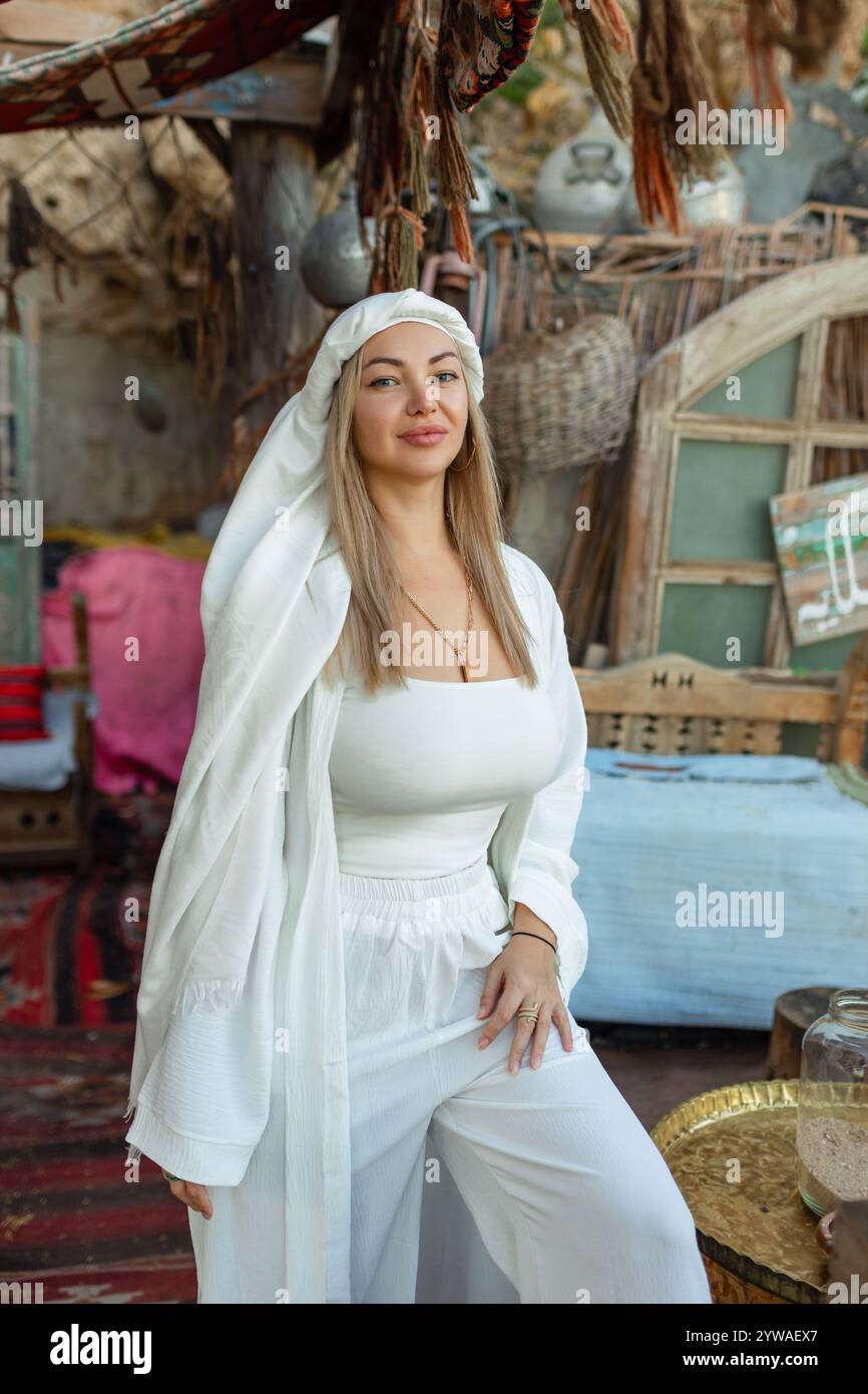Portrait of a beautiful woman in Arabic clothing in Egypt during sunset ...