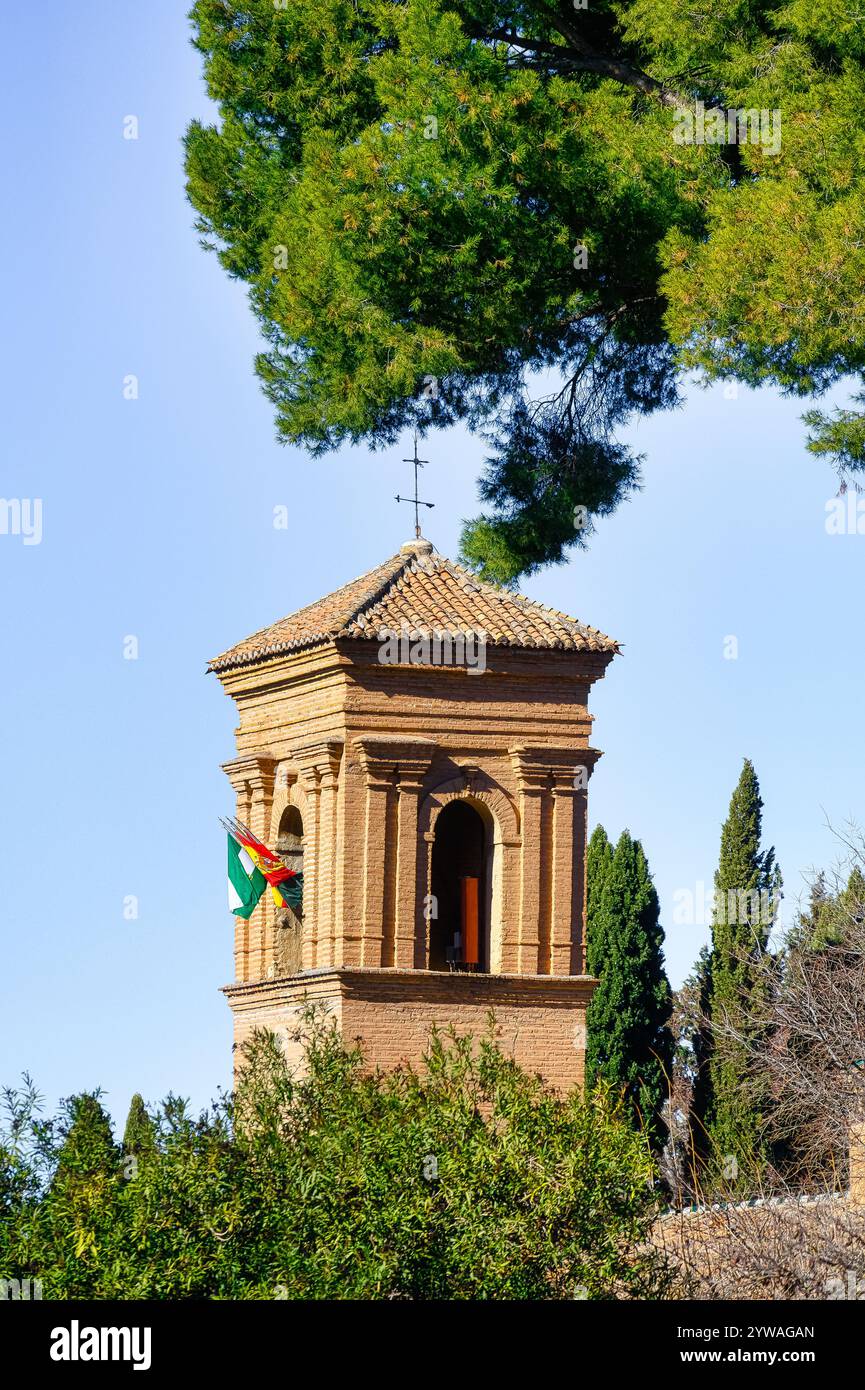 Granada, Spain - September 20, 2024: Ancient tower framed by trees in ...