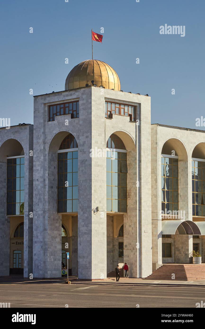 Historical building with golden dome and flag of Kyrgyz Republic. Ala ...