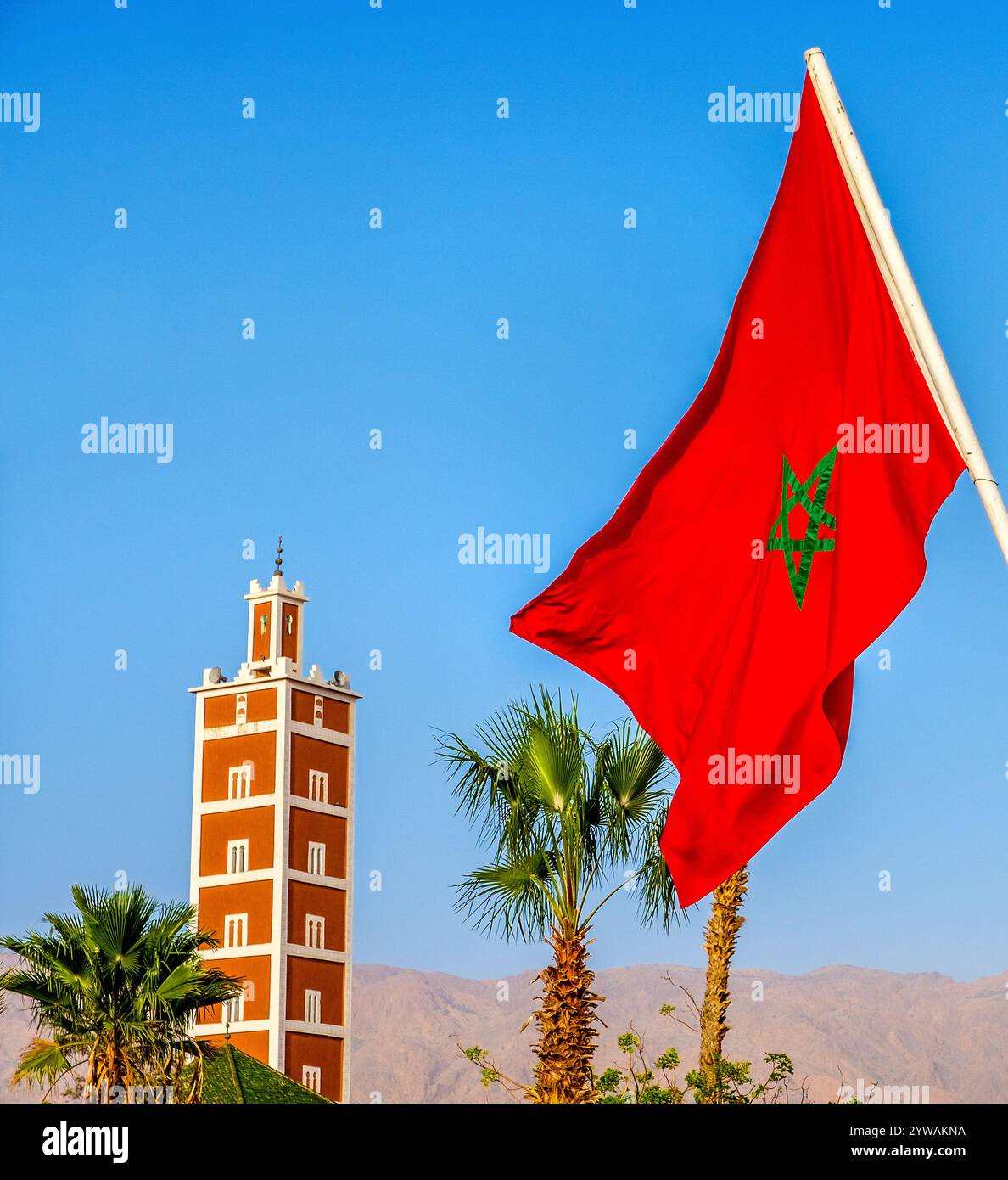 Moroccan flags and a minaret of a mosque in Tafraoute, Morocco Stock ...