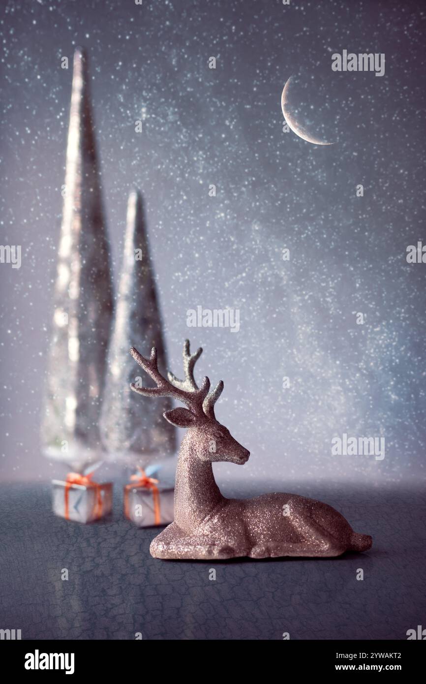 A Christmas still life composite of a golden deer with Christmas trees ...