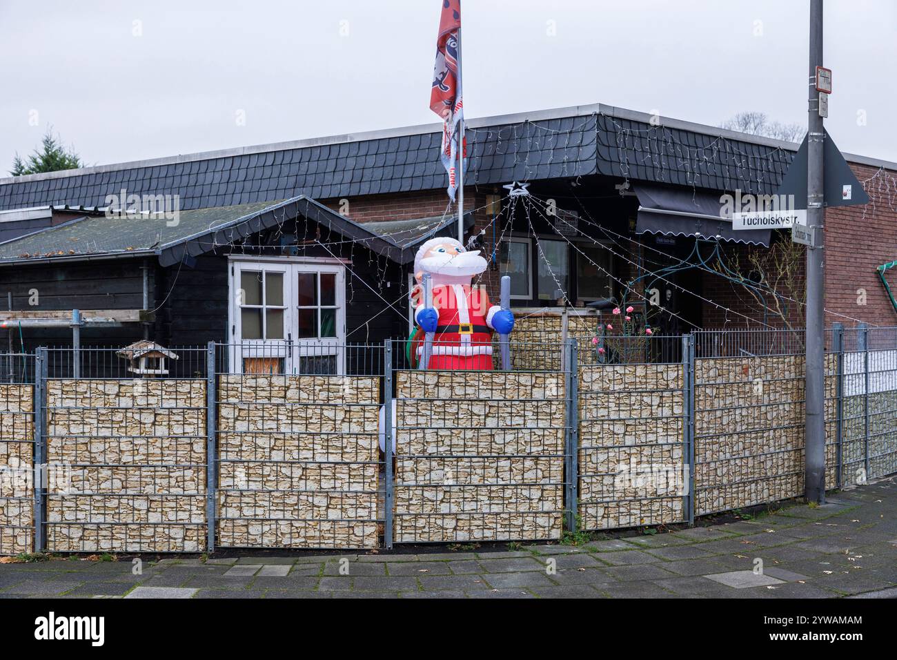 inflatable Santa Claus at a fenced-in residential building in the ...