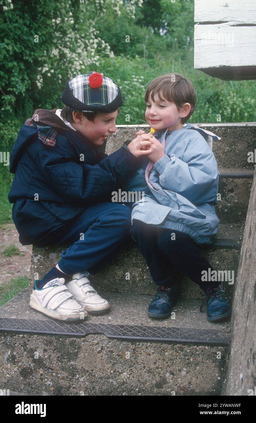 An eight year old English boy teases his five year old sister in an ...