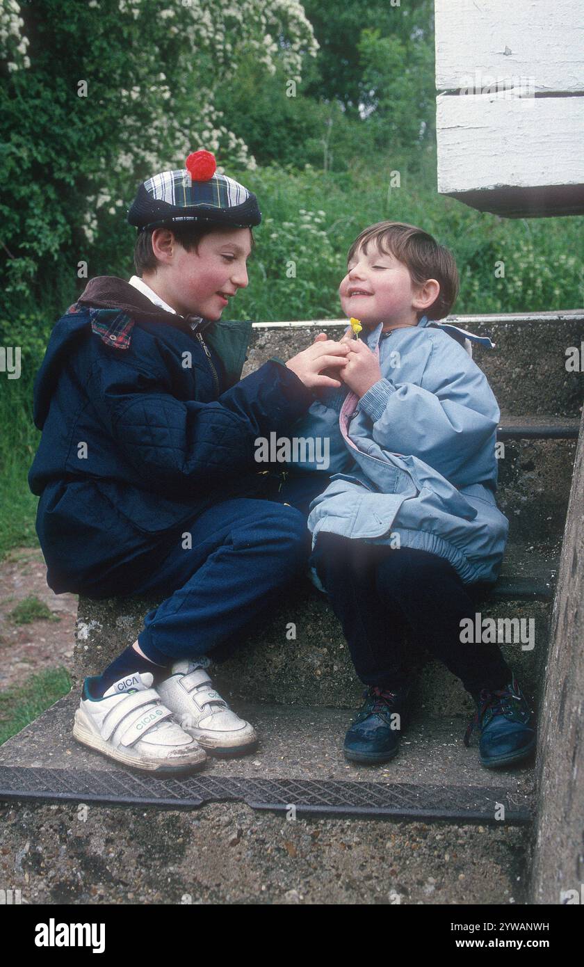 An eight year old English boy teases his five year old sister in an ...