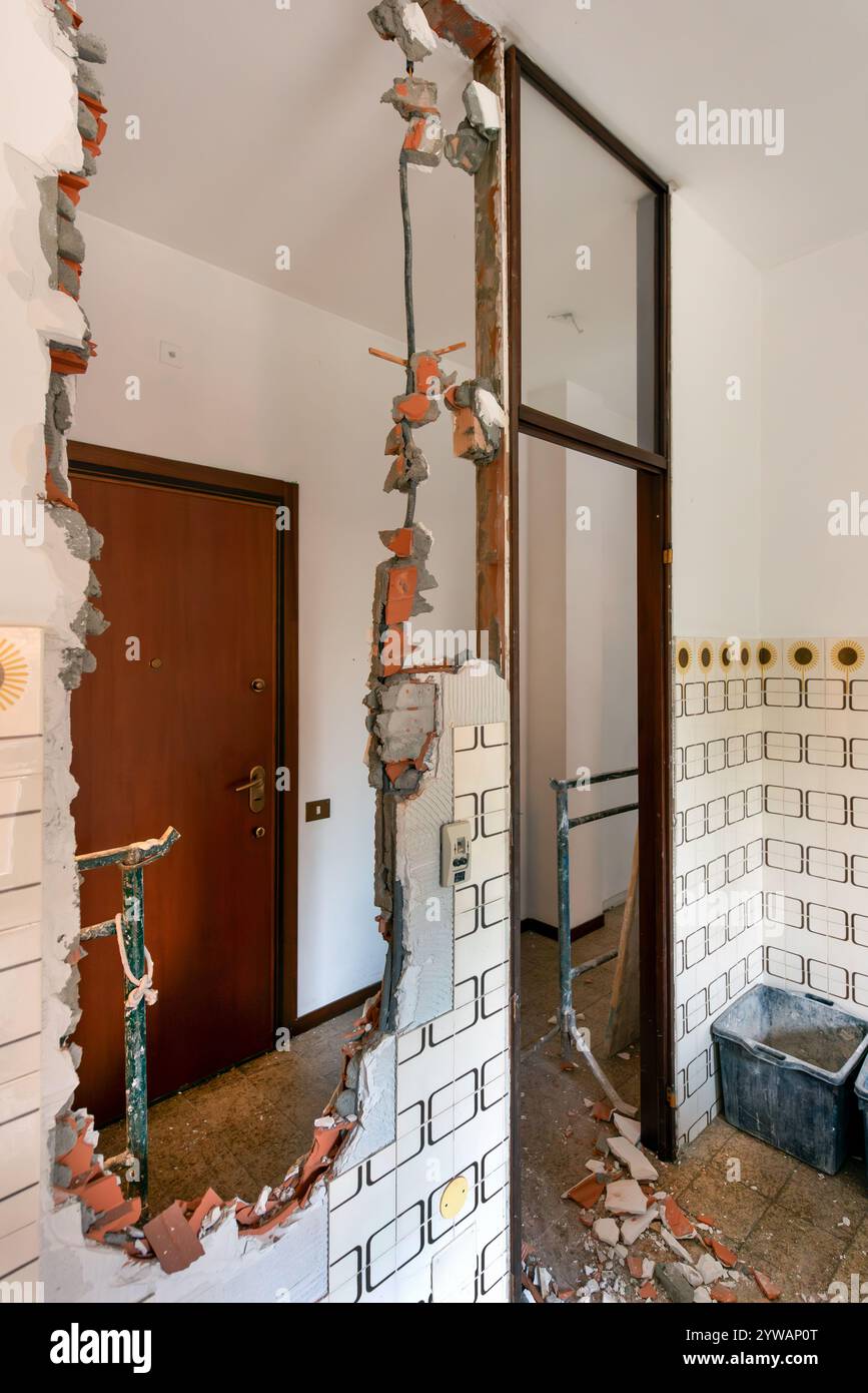 Demolishing a wall during home renovation, creating an opening between ...