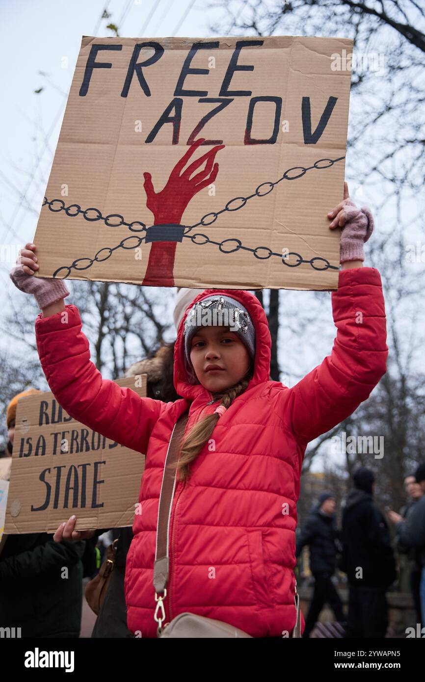 Little Ukrainian girl posing with a poster Free Azov at a public event ...