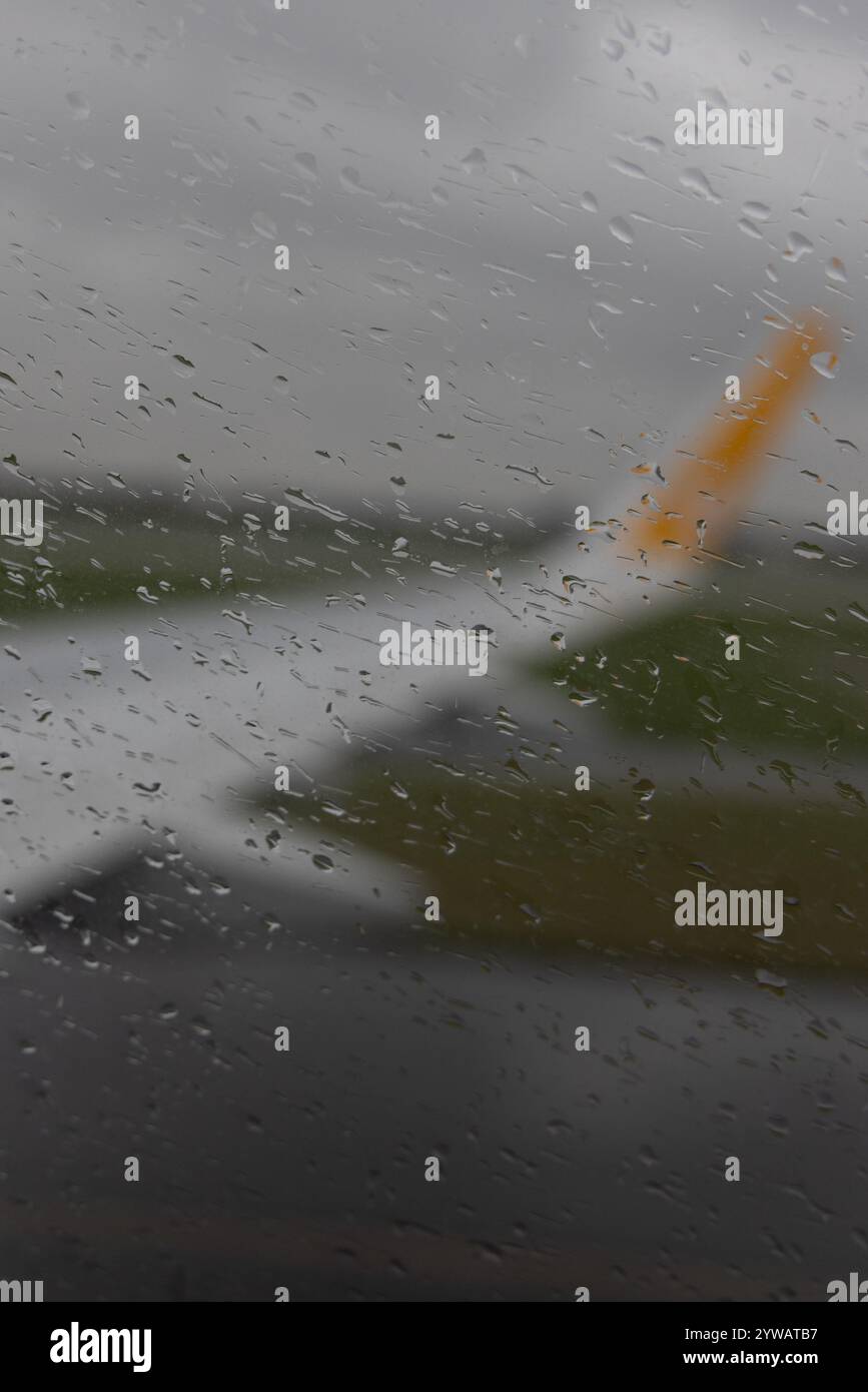 a rainy day view from an airplane window. Water droplets are scattered ...