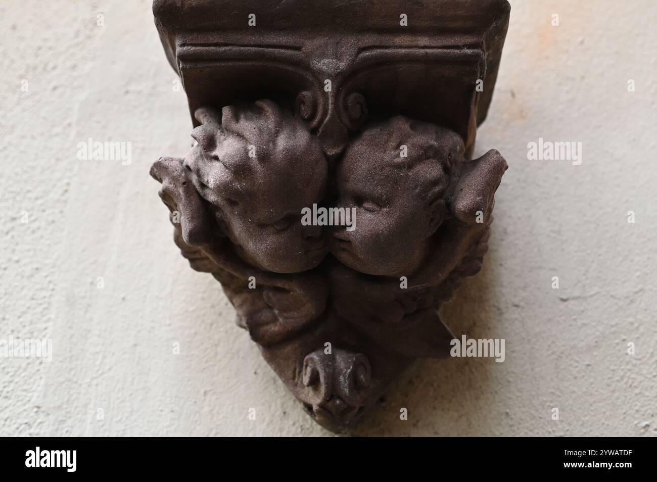 A male statue of angels on the wall of a house in Bacharach Stock Photo ...
