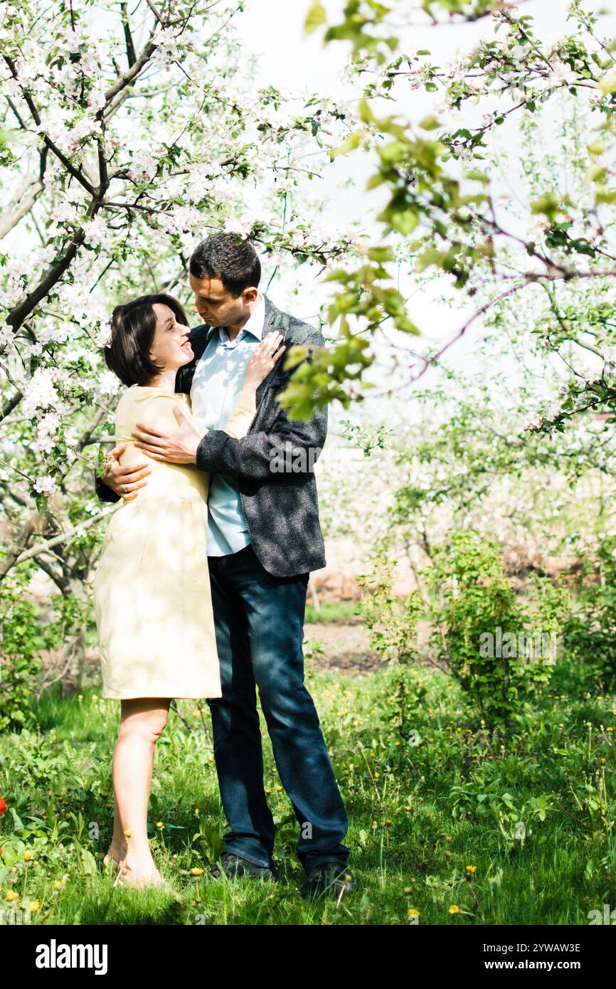 Happy pregnant couple in blossom hi-res stock photography and images ...