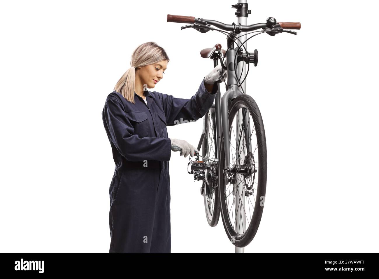 Woman mechanic fixing a bicycle on a stand isolated on white background ...