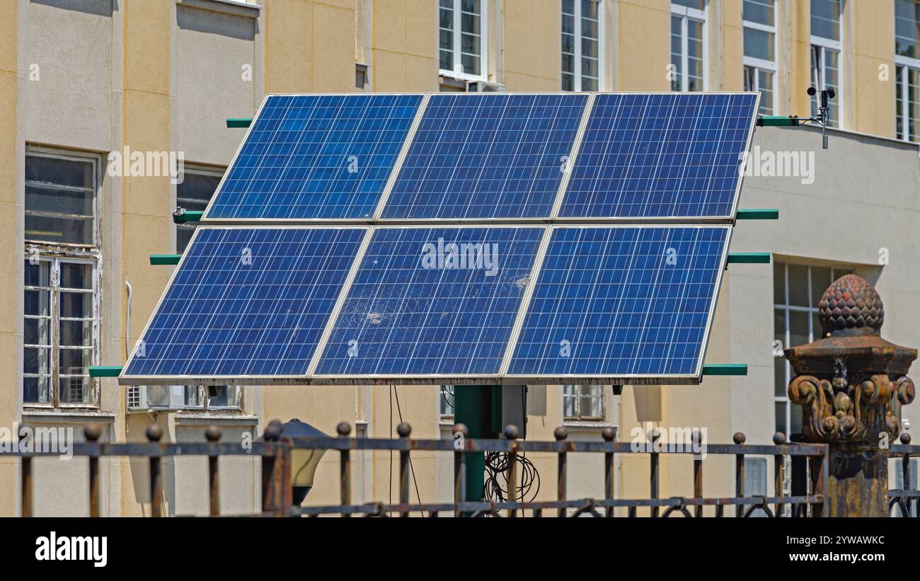 Solar Panels Set With Sun Tracker System Building Power Stock Photo - Alamy