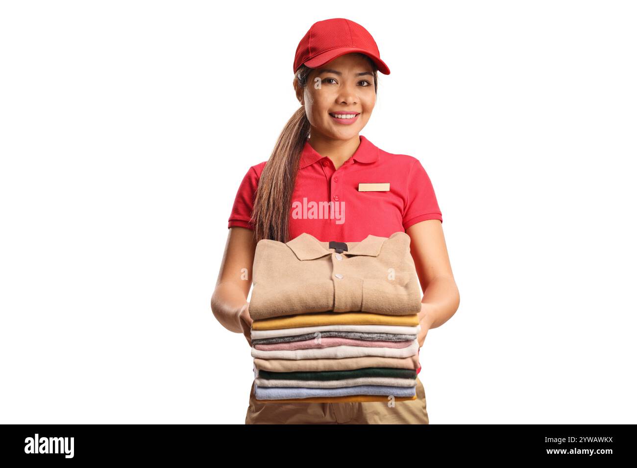 Female dry cleaning worker holding a pile of clothes isolated on white ...