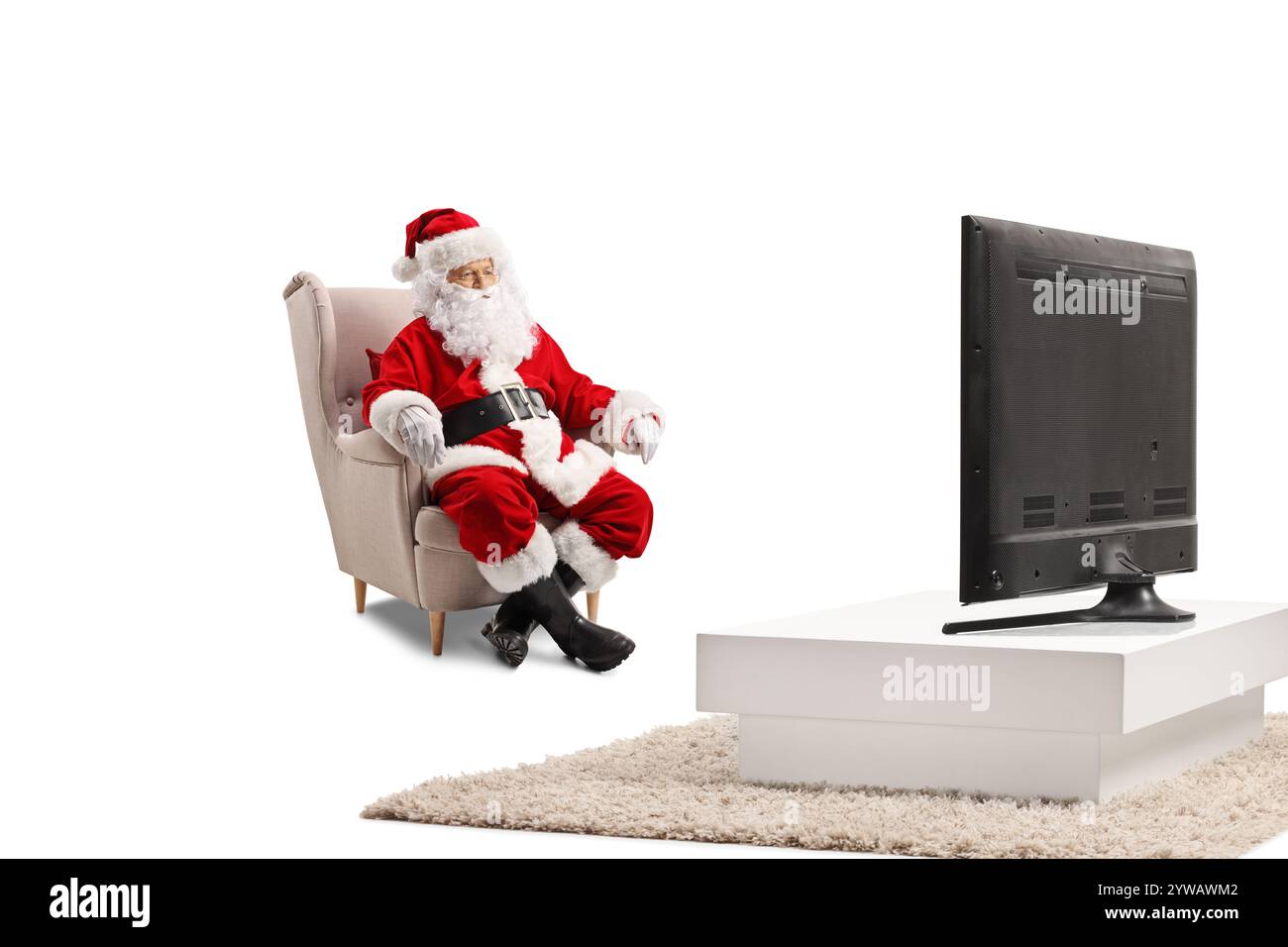 Santa claus sitting in an armchair and watching television isolated on white background Stock ...