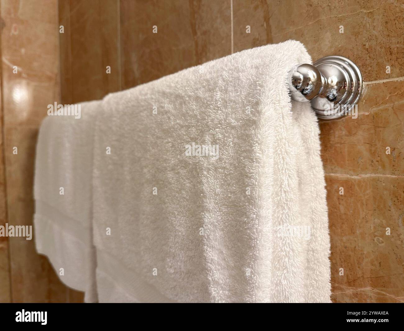 Soft terry towels hanging on rail in bathroom Stock Photo - Alamy