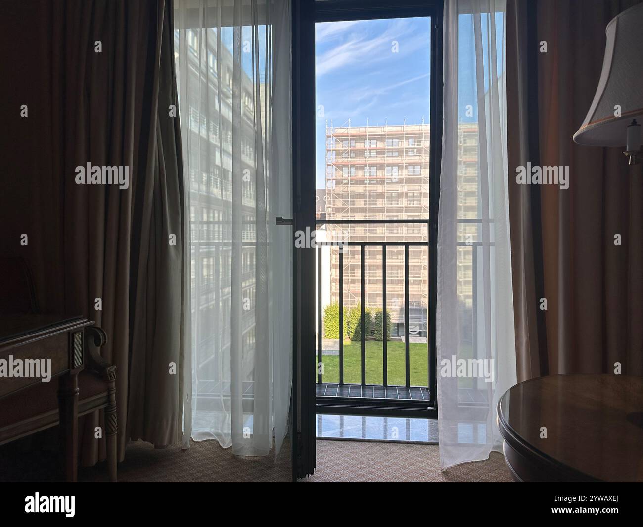 View on hotel garden through open balcony door Stock Photo - Alamy