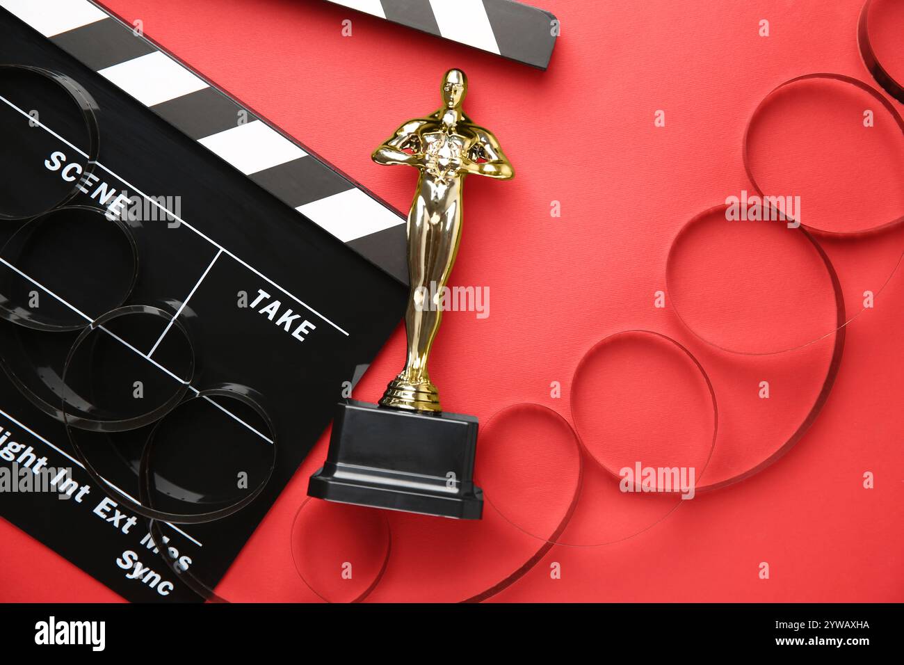 Golden trophy in shape of human figure, movie clapper and film reel on ...