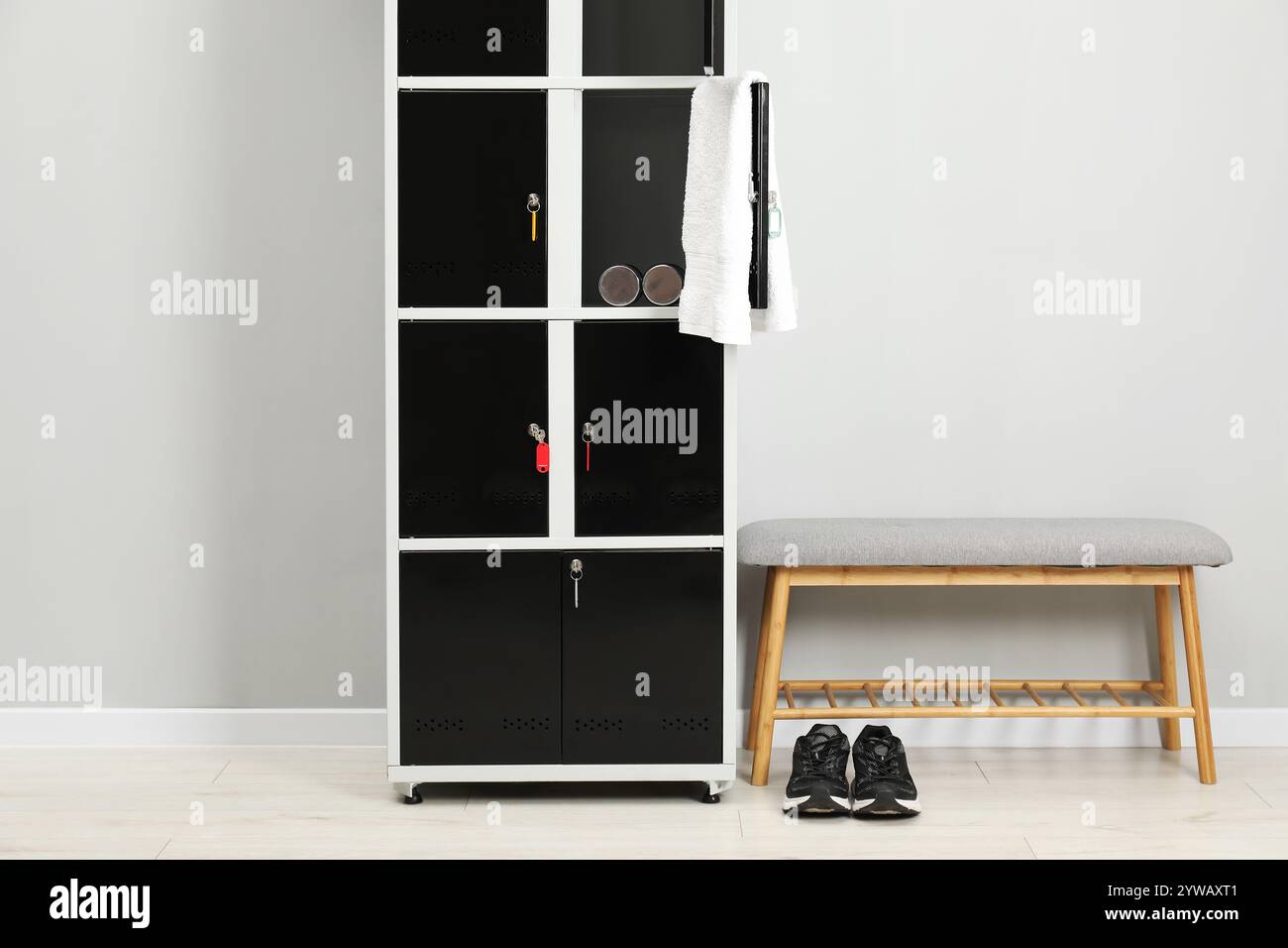 Lockers with personal belongings and bench in changing room at gym ...