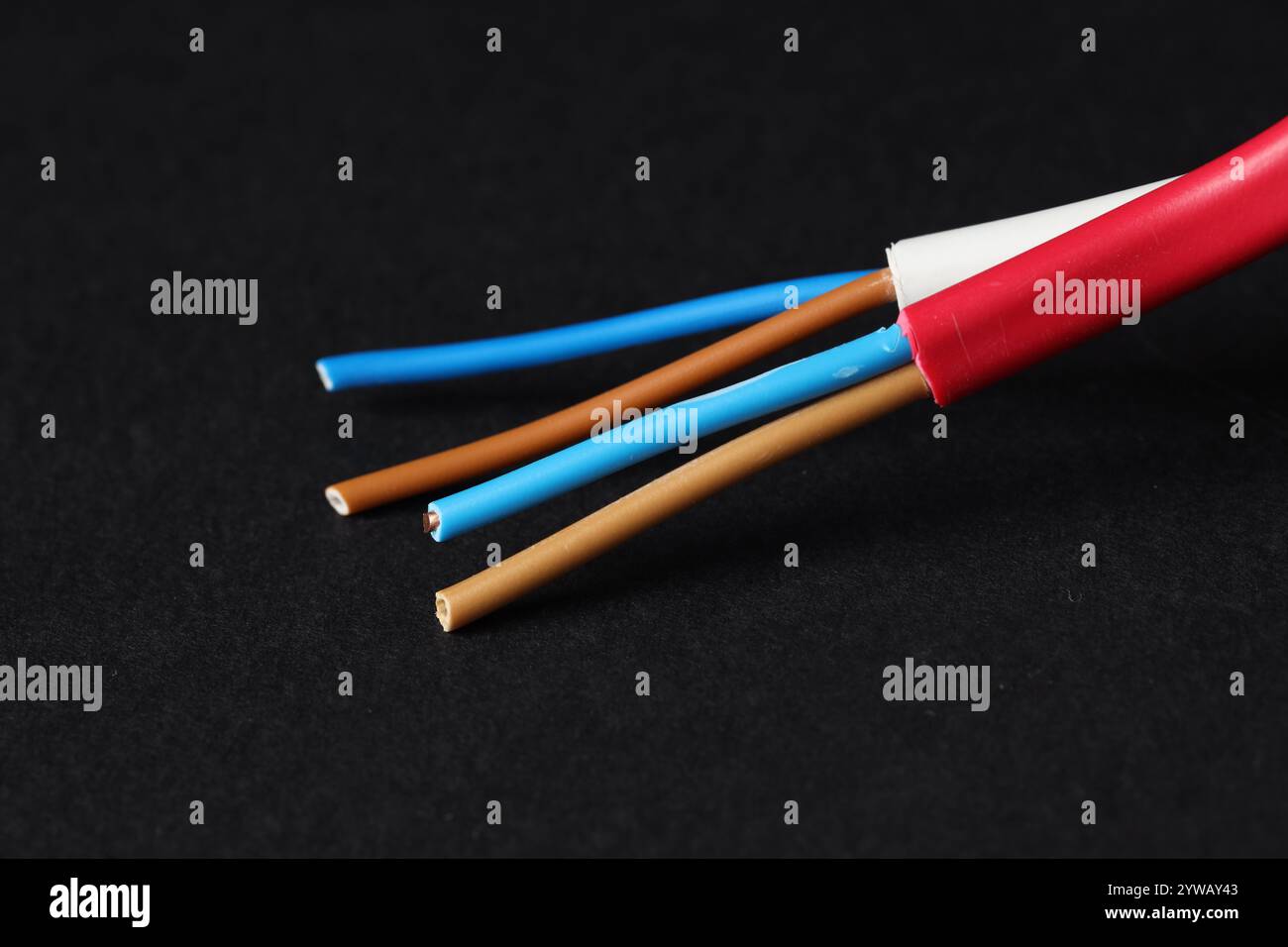 Stripped electrical wire on black background, closeup Stock Photo - Alamy