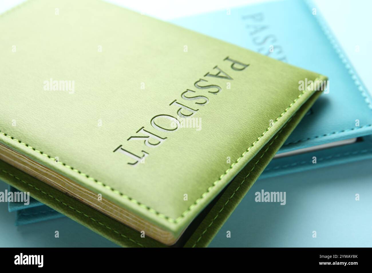 Passports in color covers on light blue background, closeup Stock Photo ...