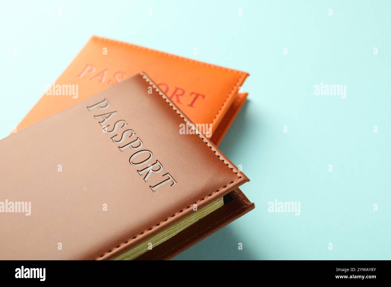 Passports in color covers on light blue background, closeup Stock Photo ...