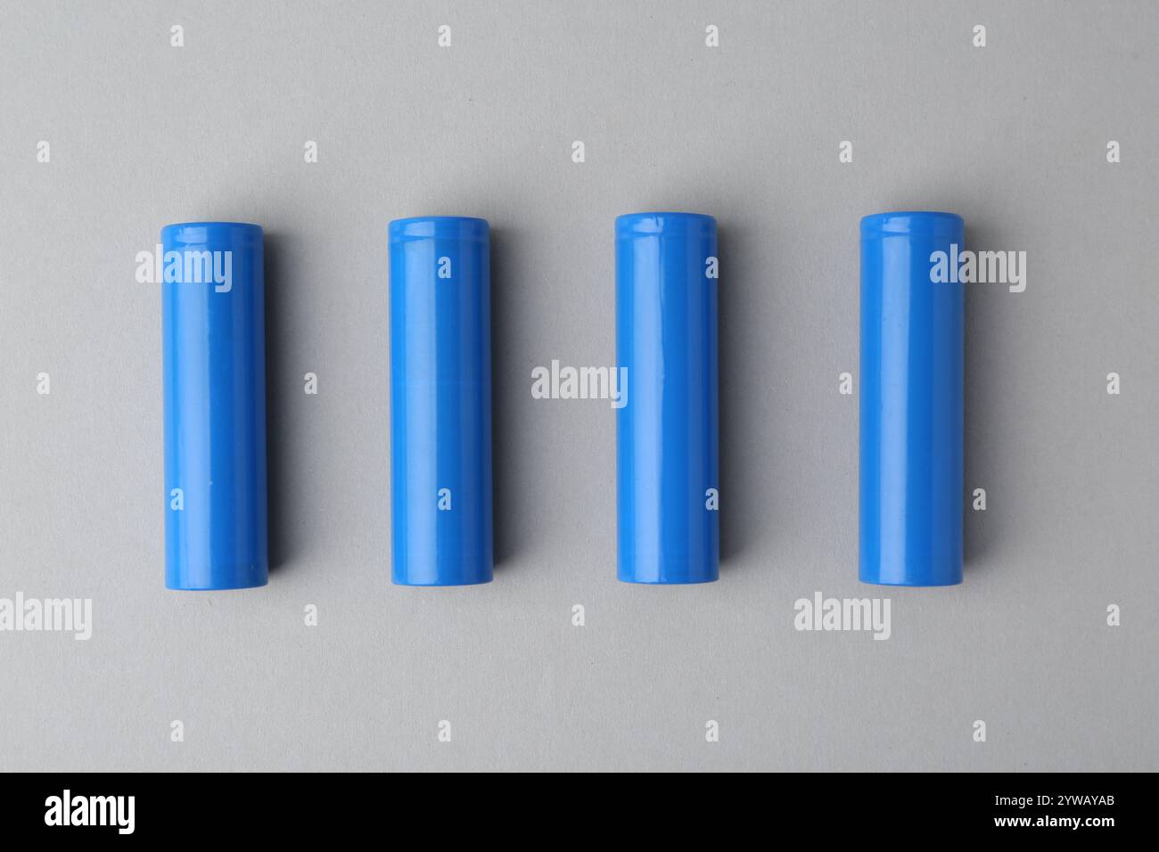 Many AA cell batteries on light grey background, top view Stock Photo ...