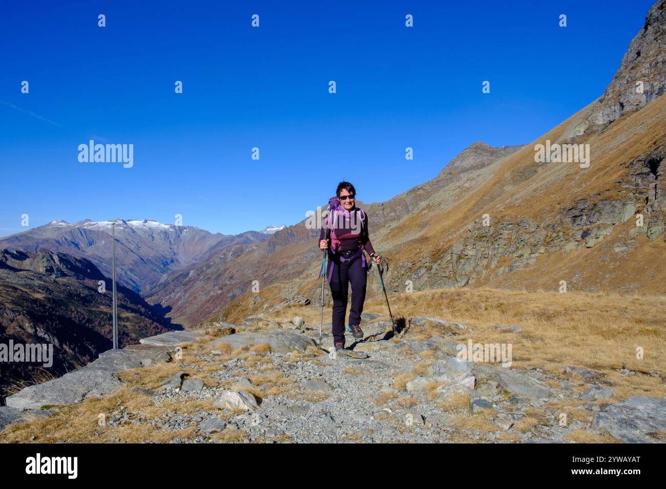 Trekker woman get to the Adula UTOE hut in Switzerland. On the ...