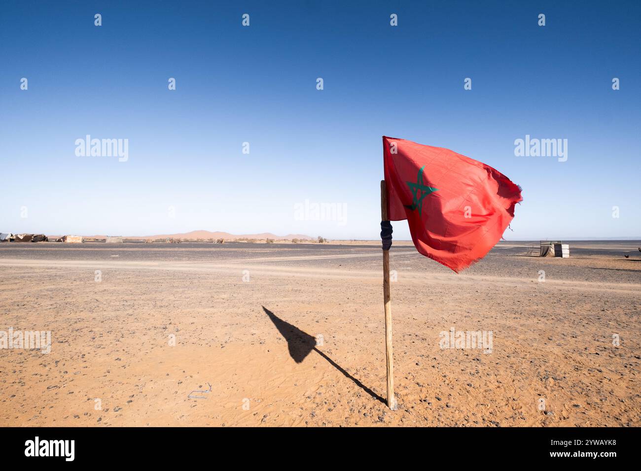 A national flag of Morocco flutters in the wind in the middle of a ...