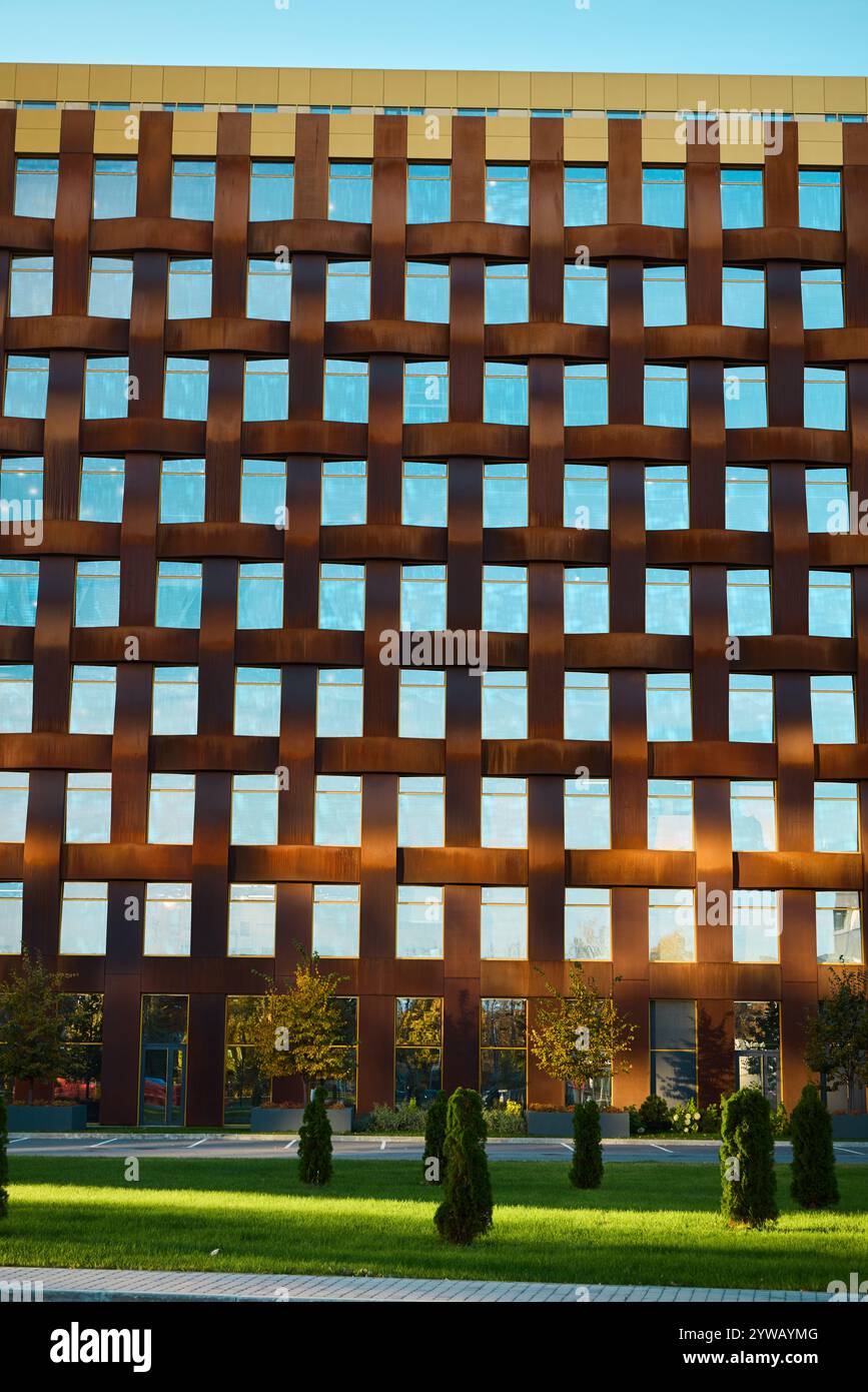 A modern architectural facade with reflective windows that enhances its ...
