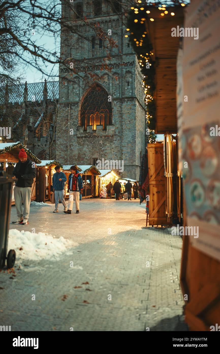 People walking between stalls in Exeter Christmas market on rainy day Stock Photo - Alamy