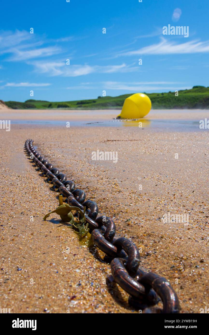 Marine Simplicity Chain Leading to a Yellow Buoy on the Shore Stock ...
