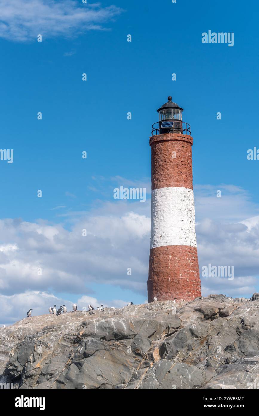 Les Eclaireurs lighthouse on rocky island with snowy mountains in ...