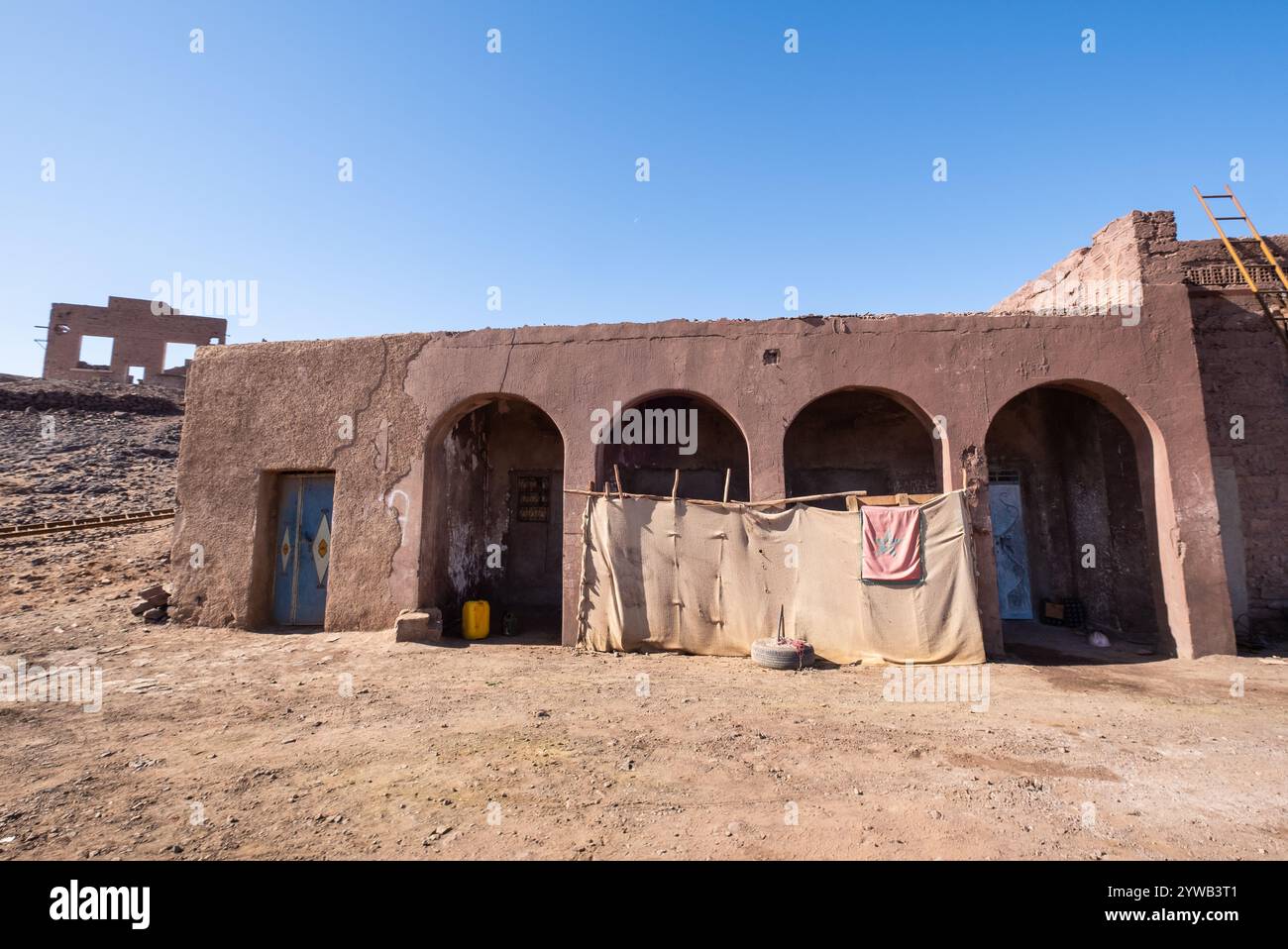 A building made of cement and mud with four arches in the middle of the ...